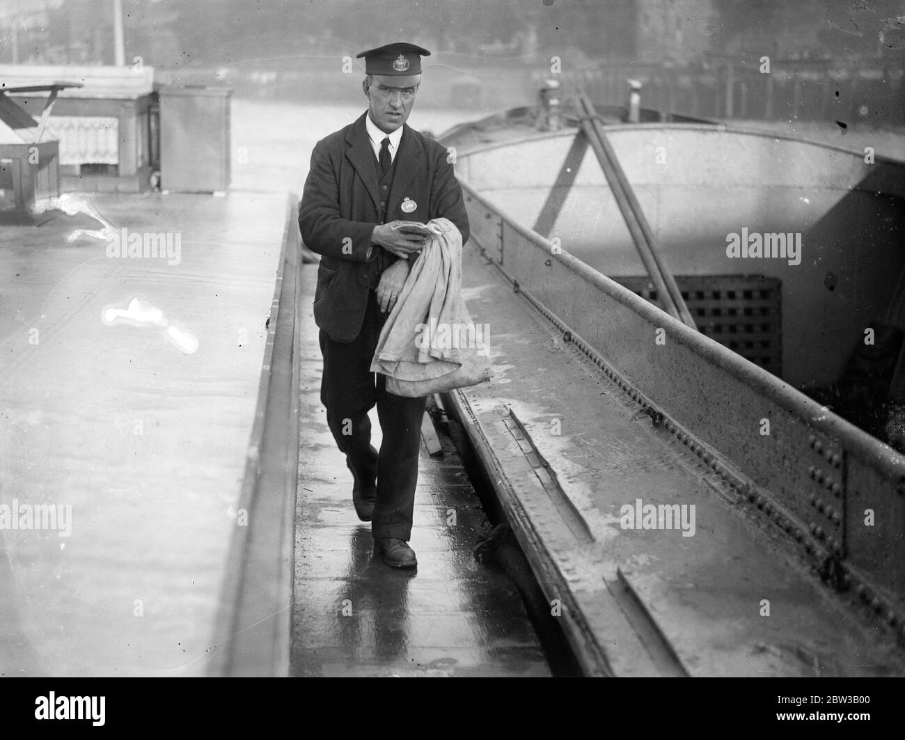 Mr H L Evans , Britain 's only river postman , making a delivery on his ...