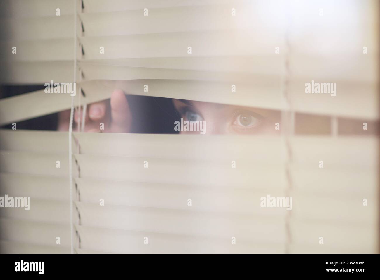Spy looking through blinds hi-res stock photography and images - Alamy