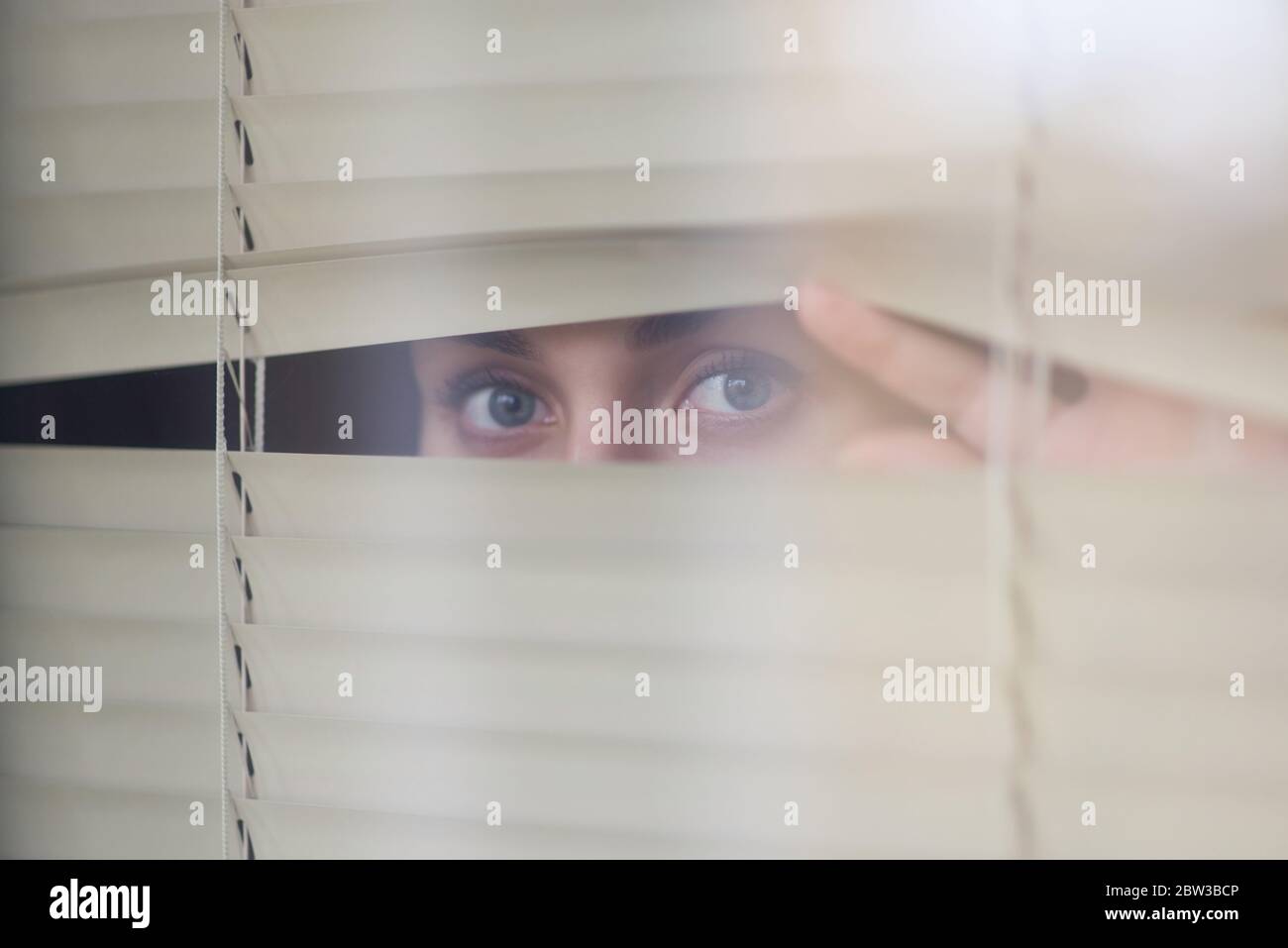 Peeping through blinds hi-res stock photography and images - Alamy
