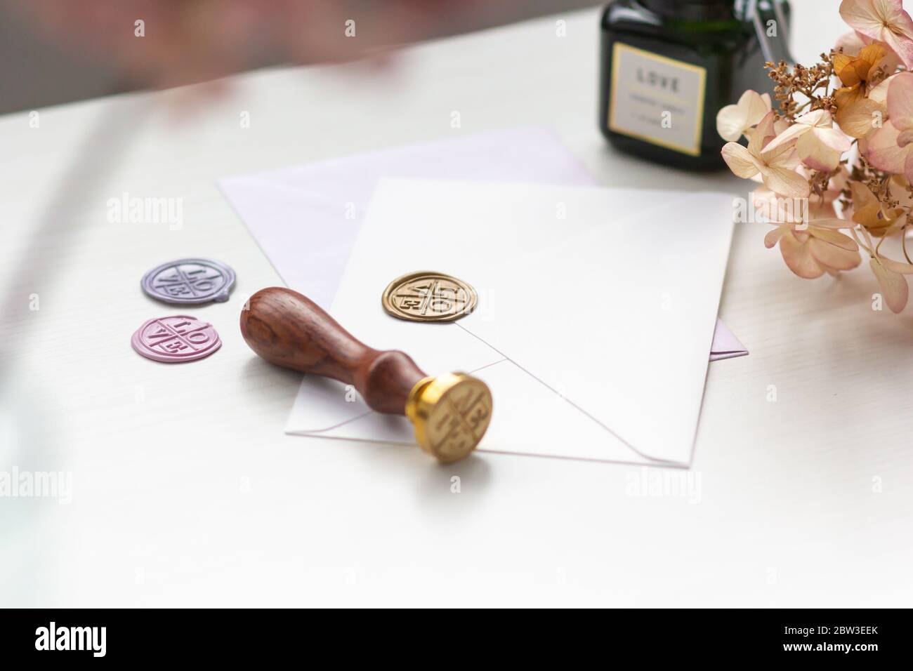 Stamp and envelopes on a light table with documents Stock Photo - Alamy
