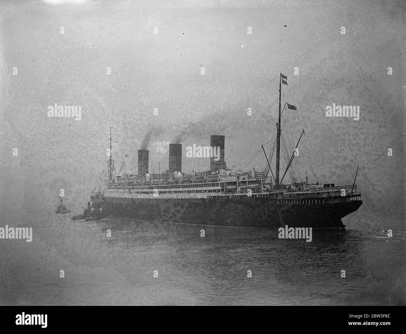 Berengaria of the Cunard fleet under the watchful eyes of the tug ...
