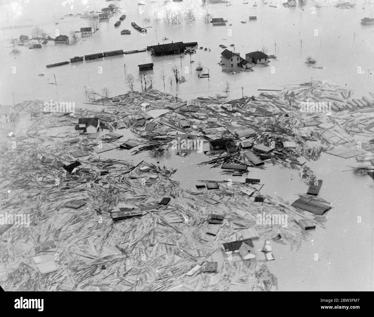Smashed buildings float on flood waters in America . Buildings smashed ...