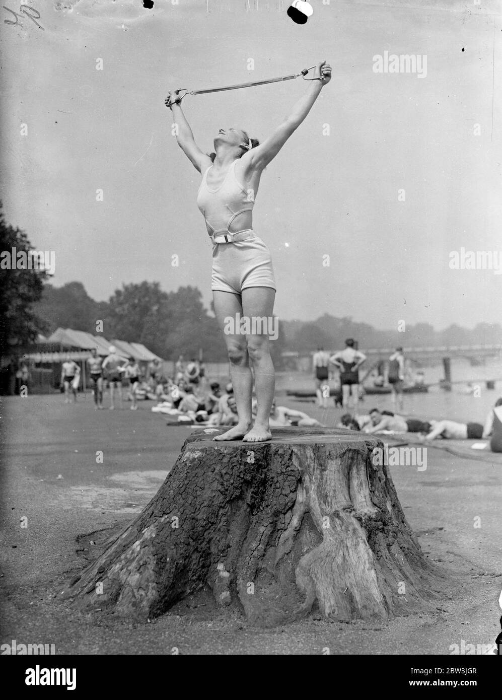 An expander to expand her . A girl sun bather excercises her muscles on ...