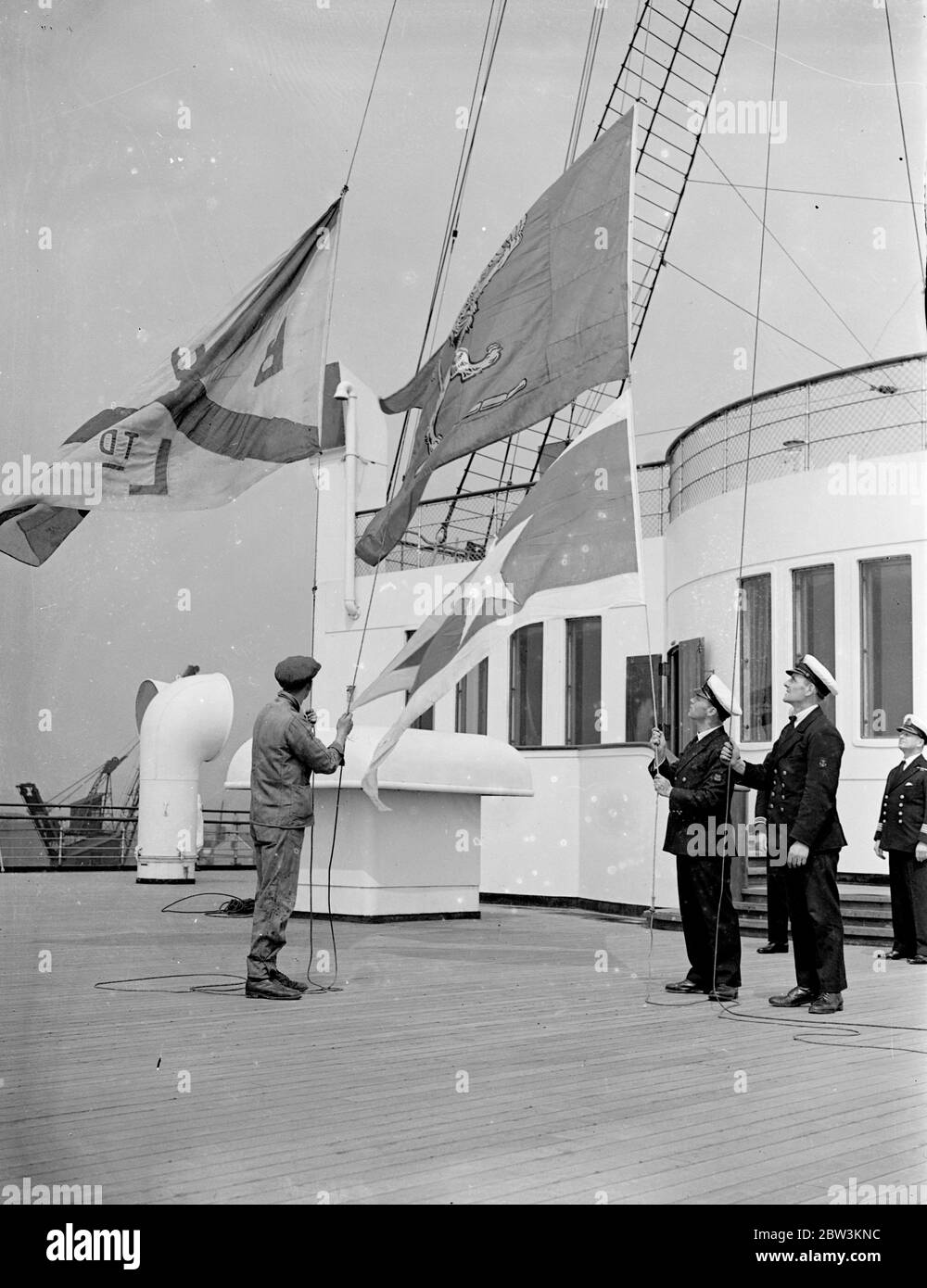 Queen Mary , handed over to Cunard White Star at Southampton , flies ...