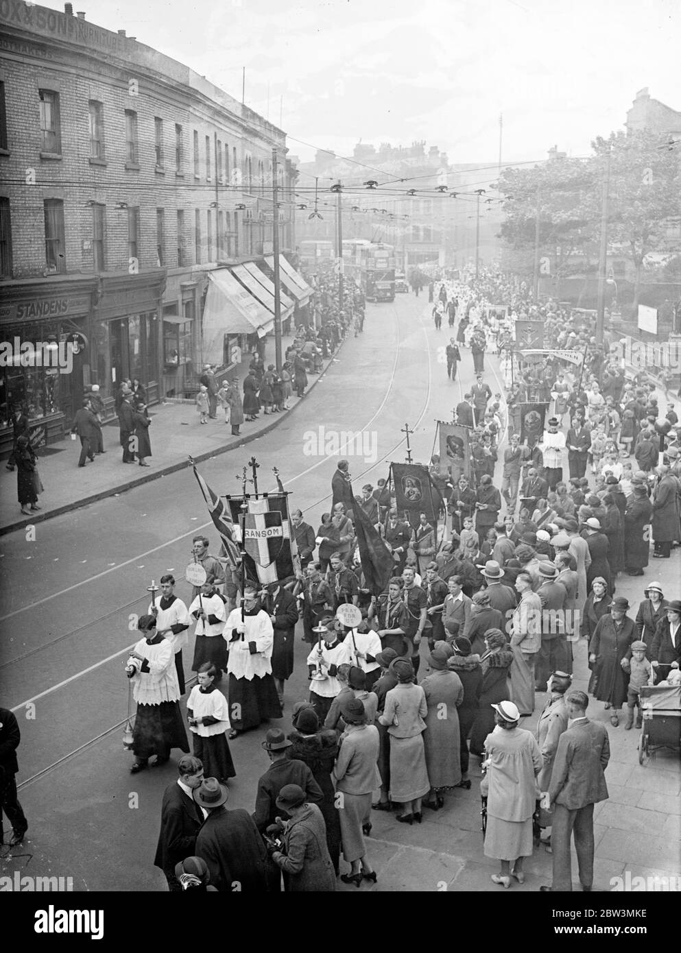 May Queen walks in catholic procession through Shepherd ' s Bush . In a ...
