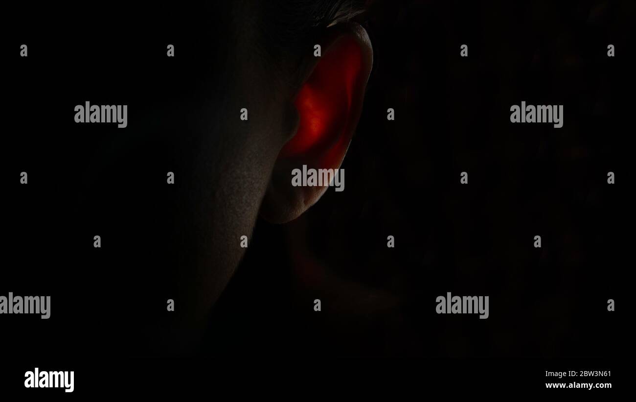 The human ear in the dark. Whisper in the dark. Big dark secrets Stock ...