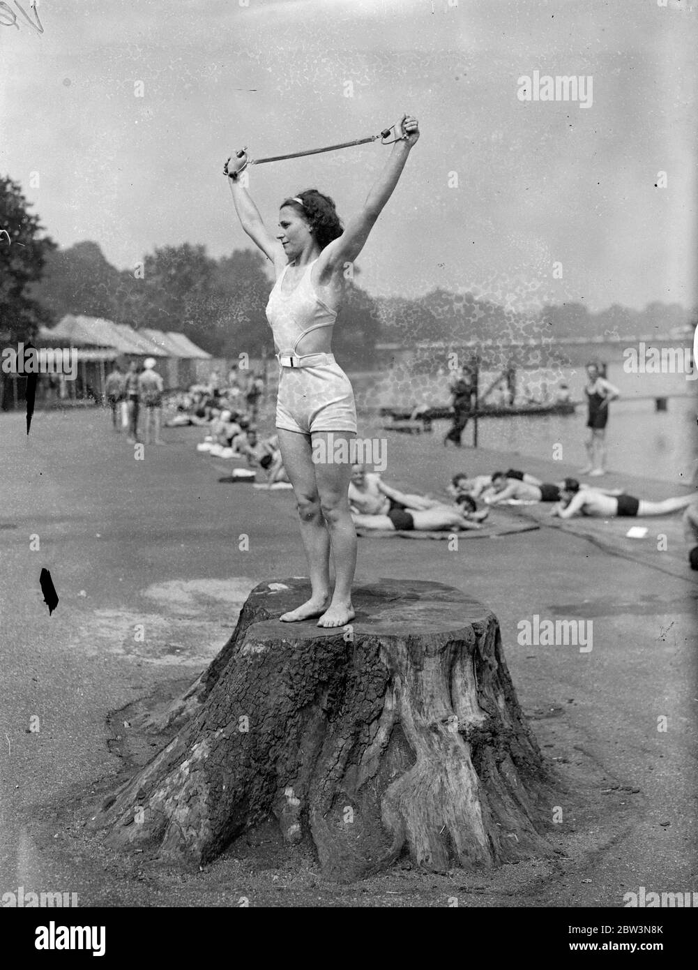 An expander to expand her . A girl sun bather excercises her muscles on ...