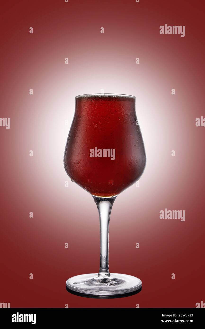 Red ale beer in tulip wineglass isolated on ruby background Stock Photo ...