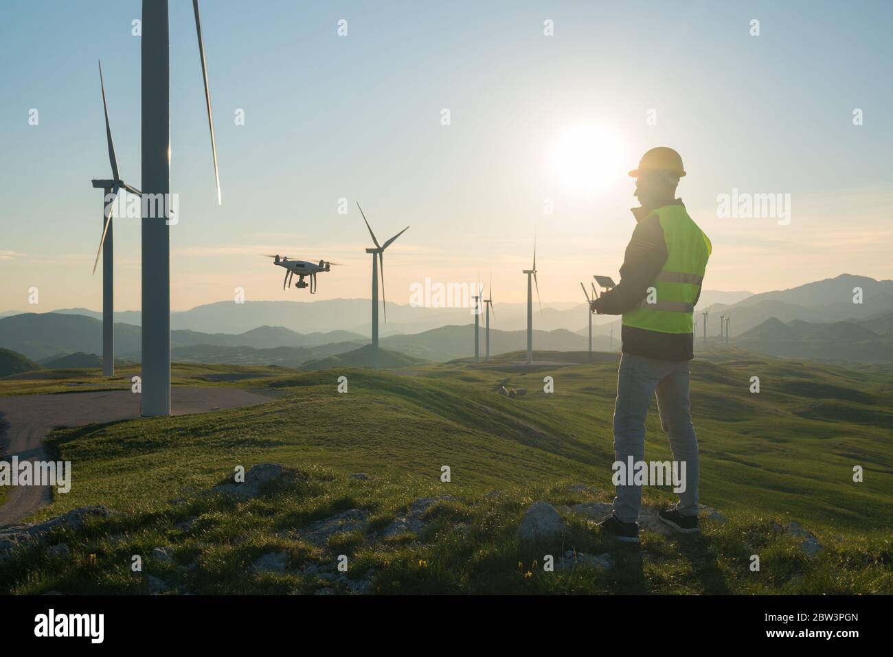 Technician Engineer in Wind Turbine Power Generator Station launches a ...