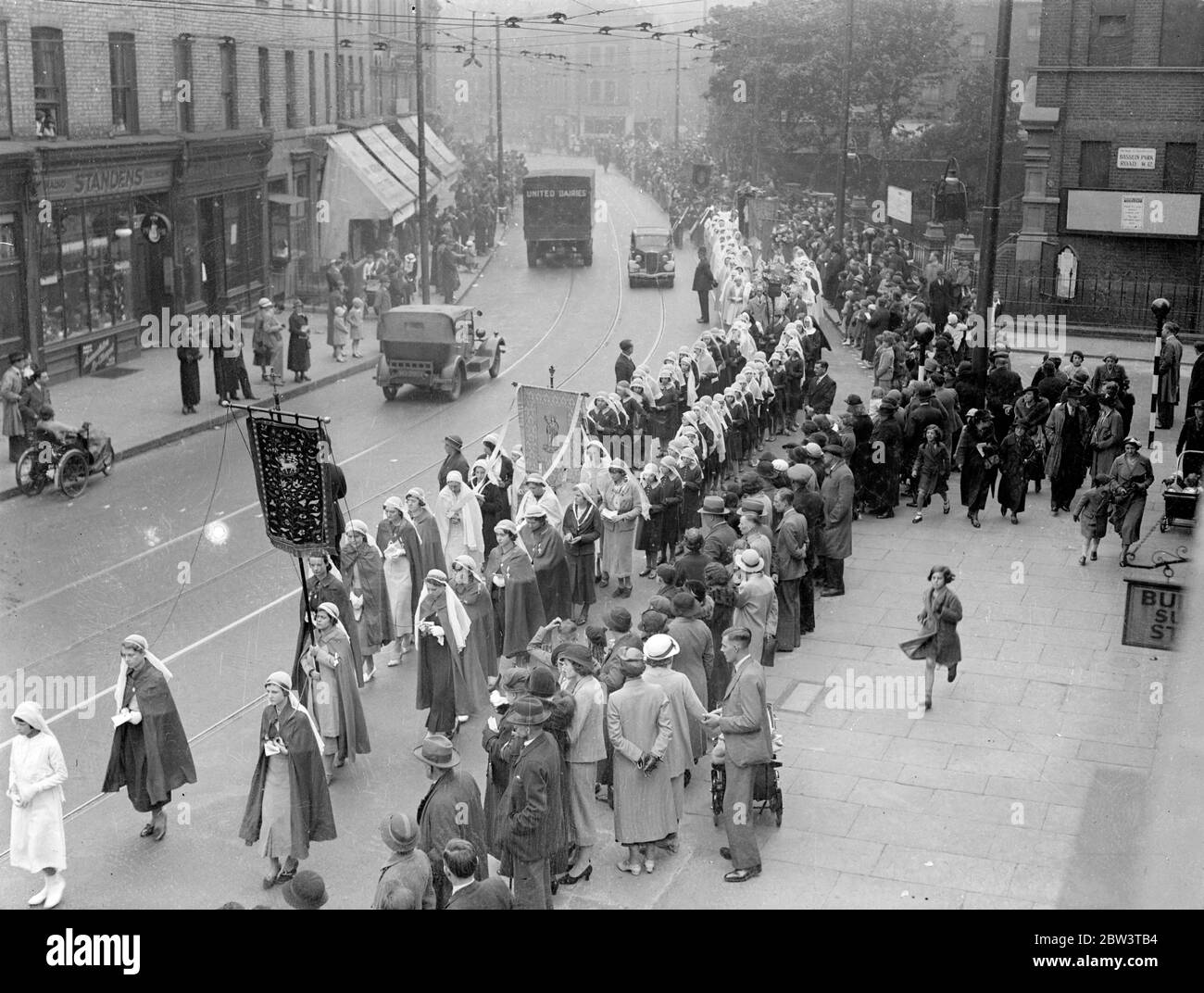 May Queen walks in catholic procession through Shepherd ' s Bush . In a ...