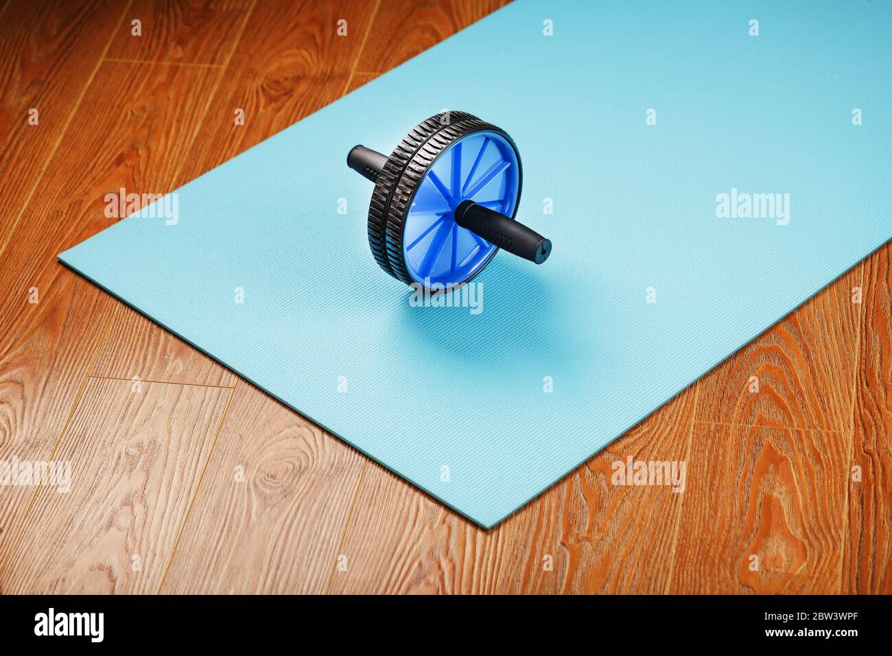 Sports roll for training muscles and abs on the blue Mat Stock Photo ...