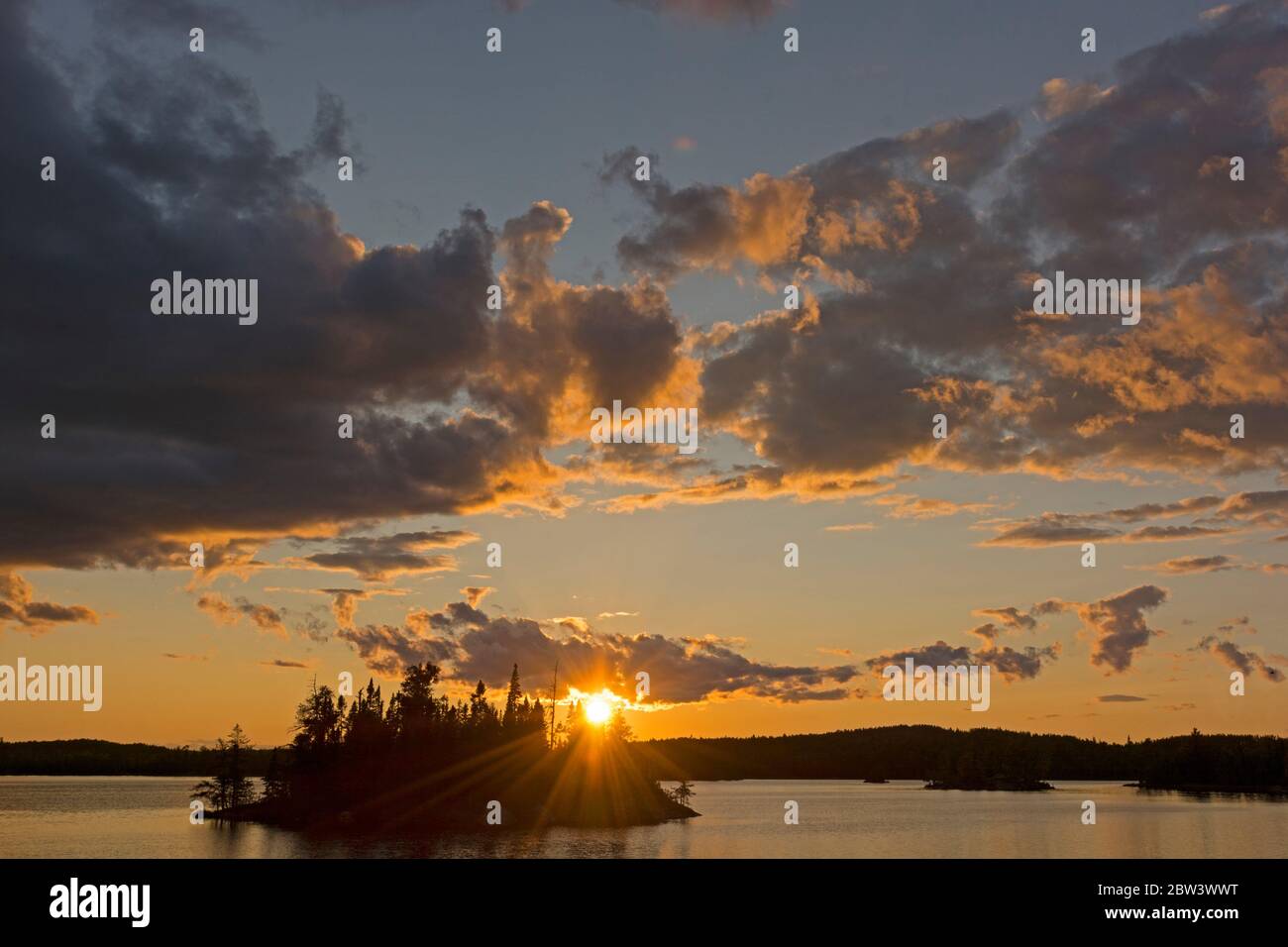 Sun Peeking Through the Clouds at Sunset on Saganagons Lake in Questico ...