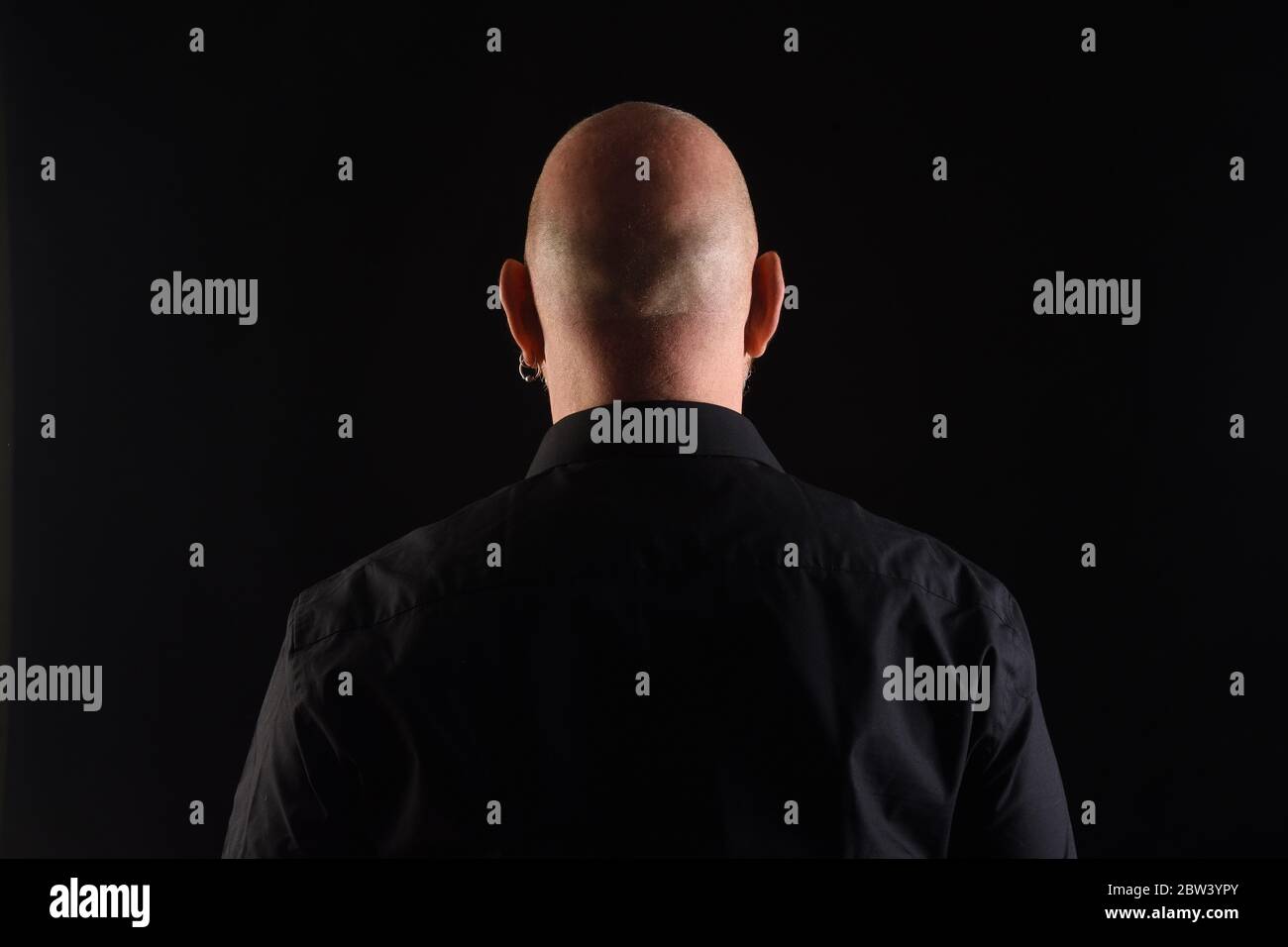 portrait of a man in low key, rear view of head Stock Photo - Alamy