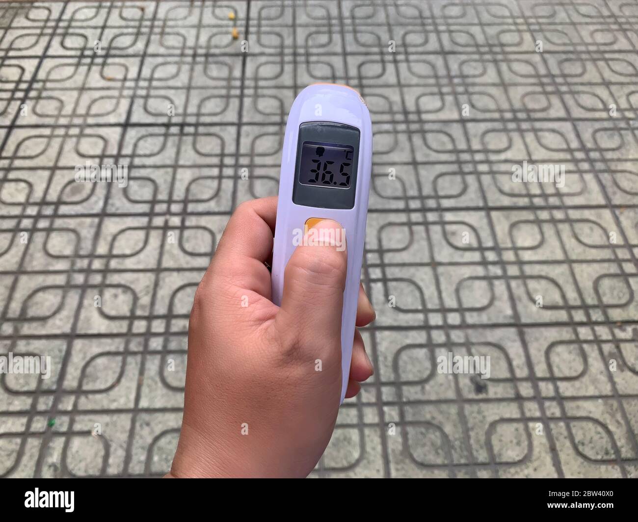 Hand holding simple Digital Infrared Thermometer (thermometer gun) for ...