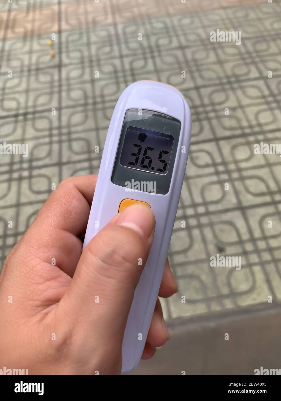 Hand holding simple Digital Infrared Thermometer (thermometer gun) for ...