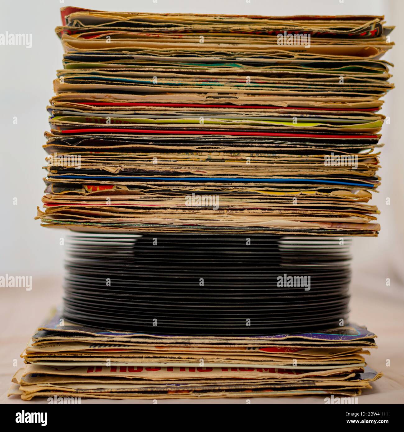 stack of 45 rpm vinyl records arranged in a vertical stack. The discs ...