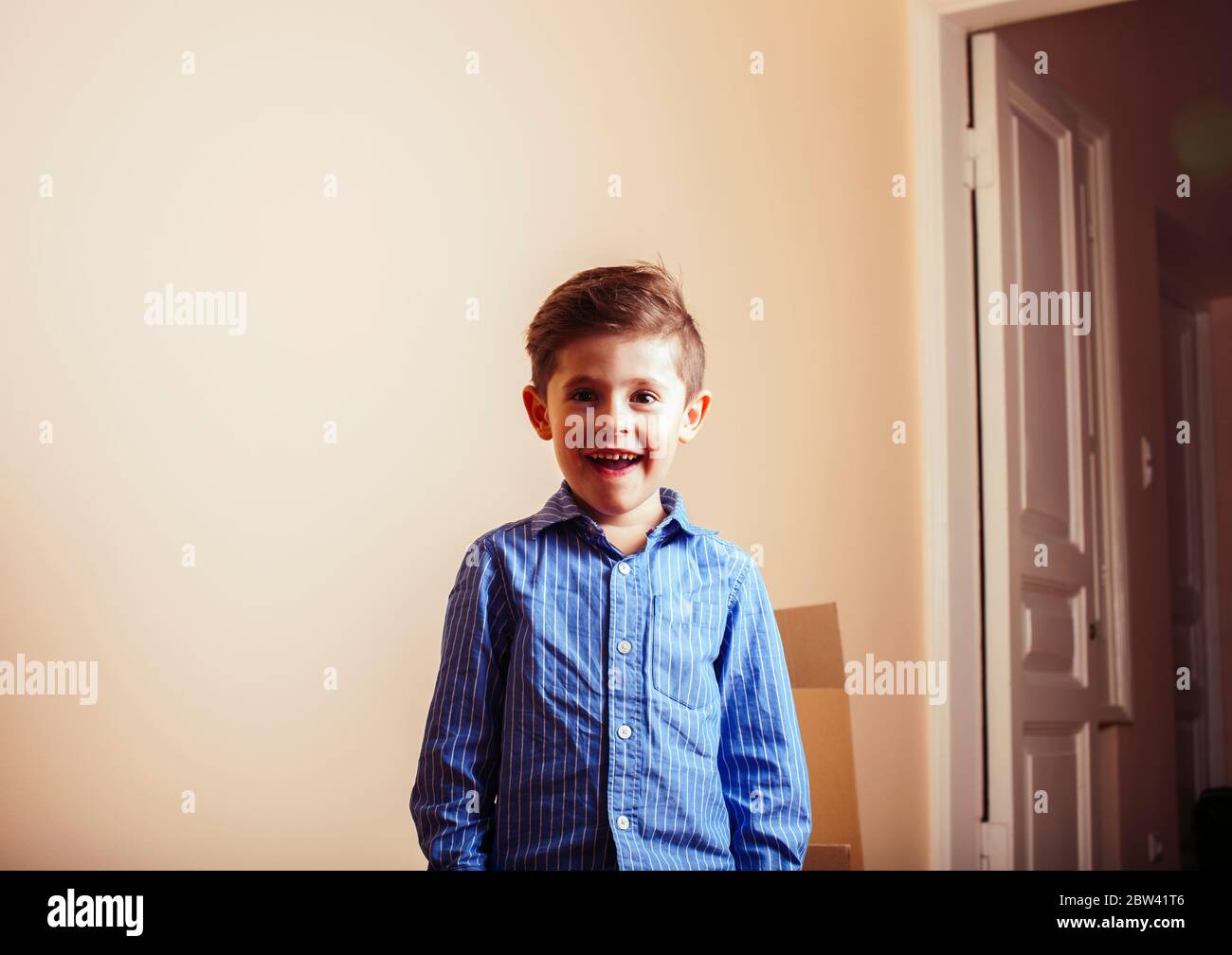 little cute boy in empty room, move to new house. home alone among ...