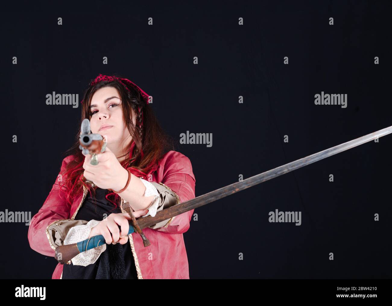 pirate girl with red jacket on the black background Stock Photo - Alamy