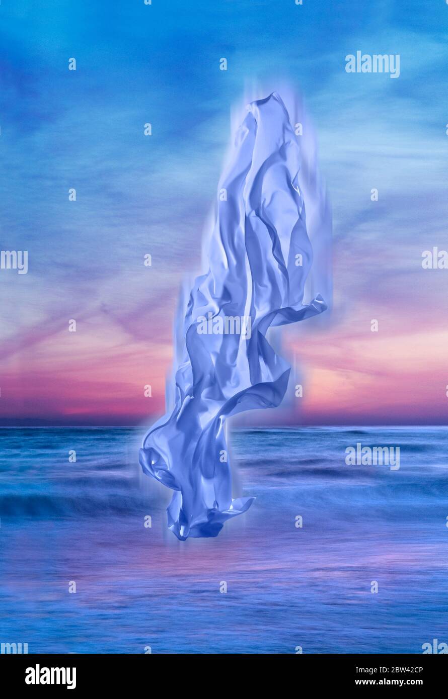 Blue fabric rising above ocean waves at sunset Stock Photo - Alamy