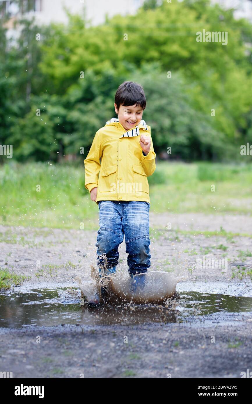 Child jumping in puddle hi-res stock photography and images - Alamy