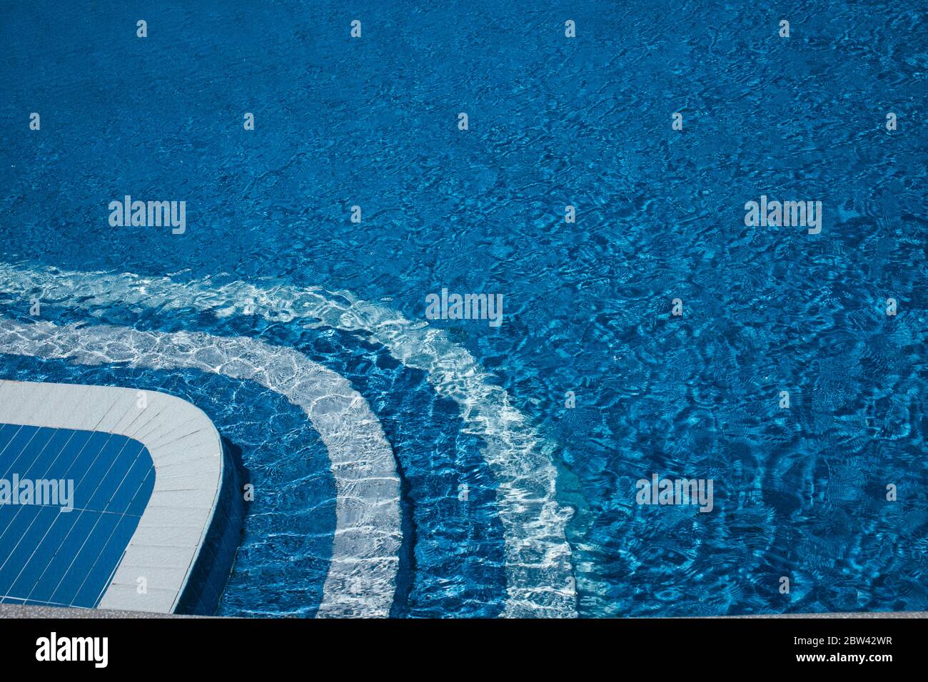 Steps to the pool, blue clear water in the outdoor swimming pool, safe ...