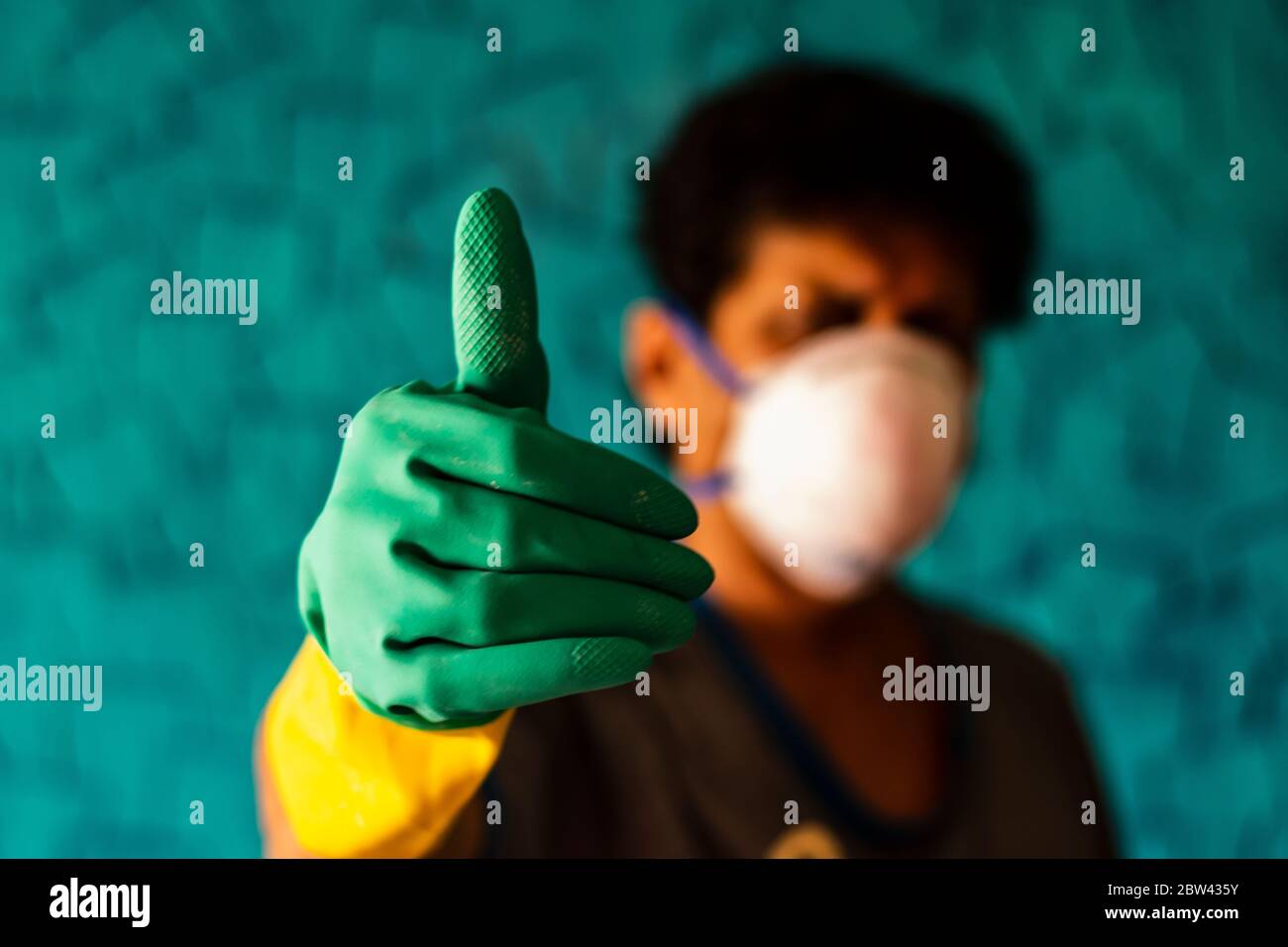 A man showing signs of positivity with his hand gloves and face mask on ...