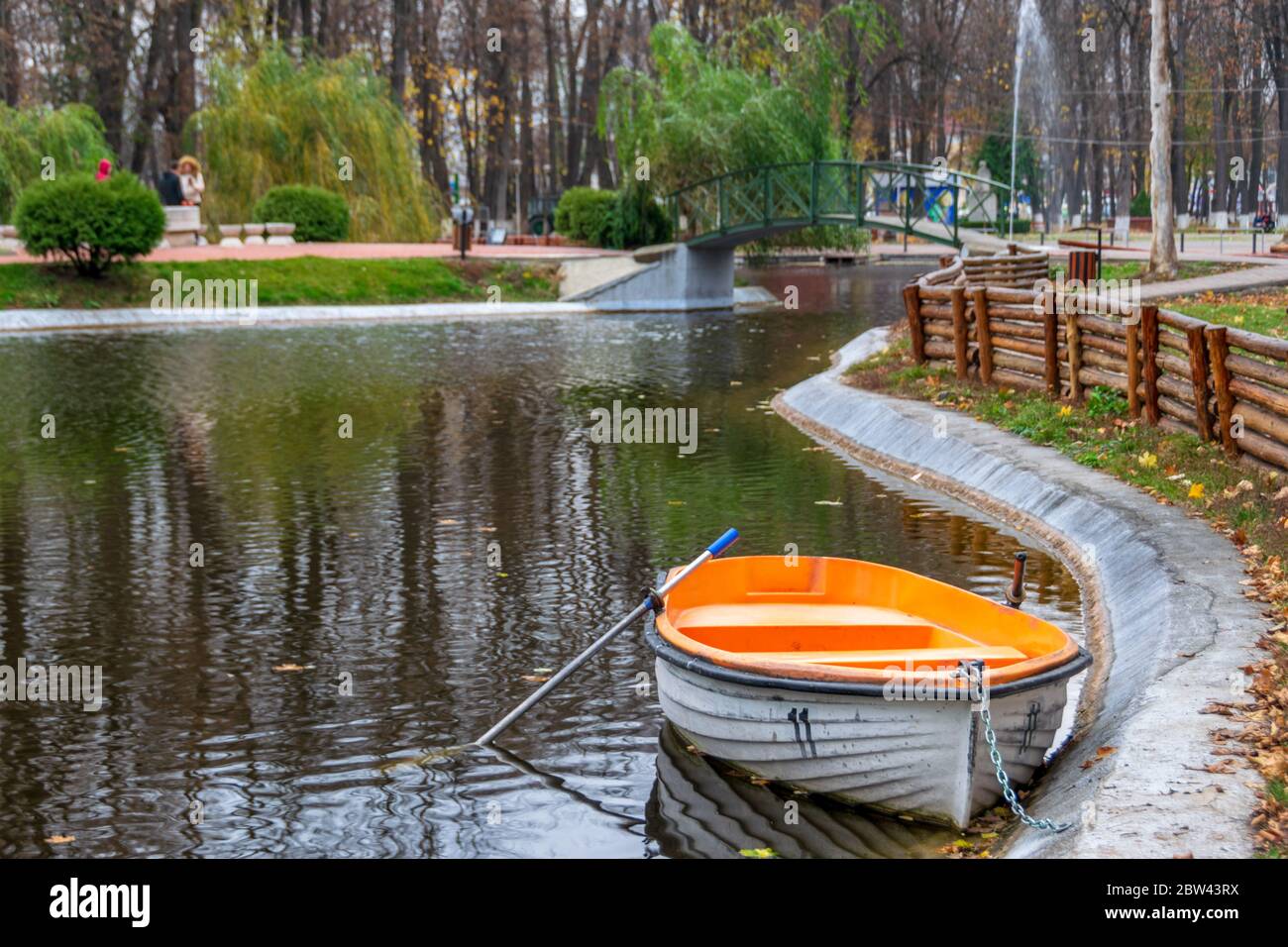 Rowing boat on the recreational lake in an autumn landscape, Roman park ...
