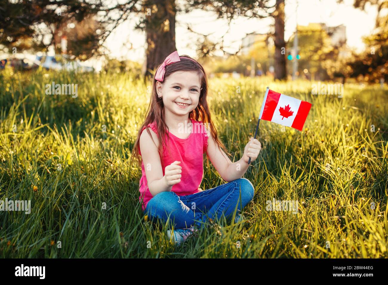 Adorable cute happy Caucasian girl holding Canadian flag. Smiling child ...