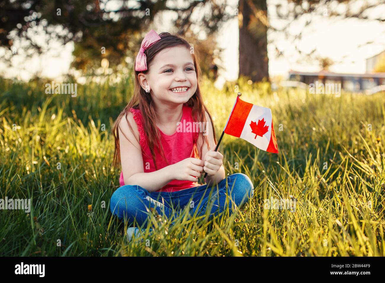 Adorable cute happy Caucasian girl holding Canadian flag. Smiling child ...