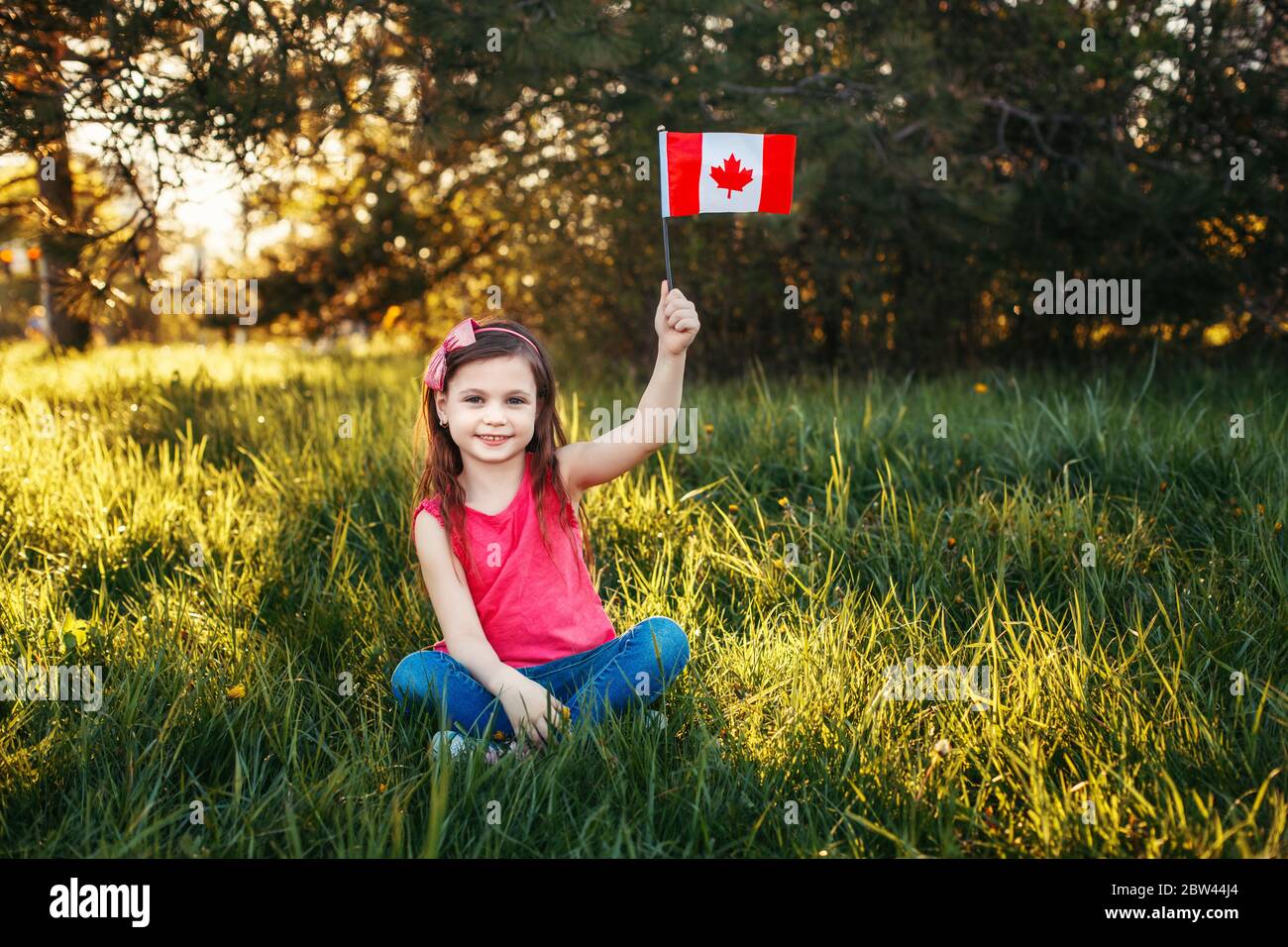 Adorable cute happy Caucasian girl holding Canadian flag. Smiling child ...