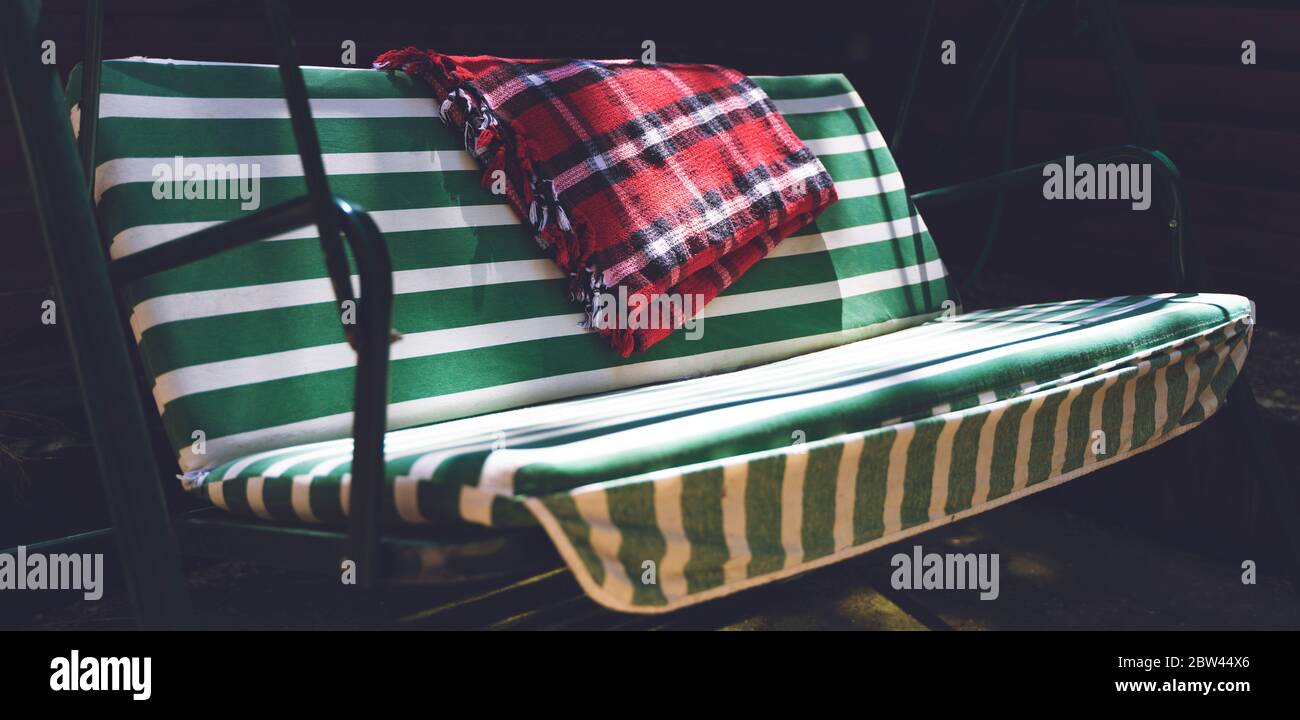 Green swing in the garden of a private house. Ready for swing enjoyment ...