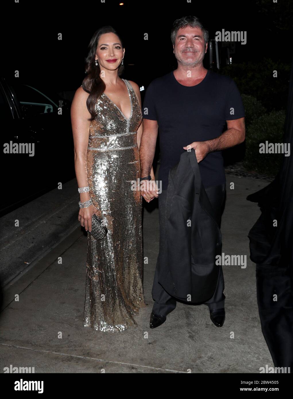 Simon Cowell and girlfriend Lauren Silverman in LA at a party to ...