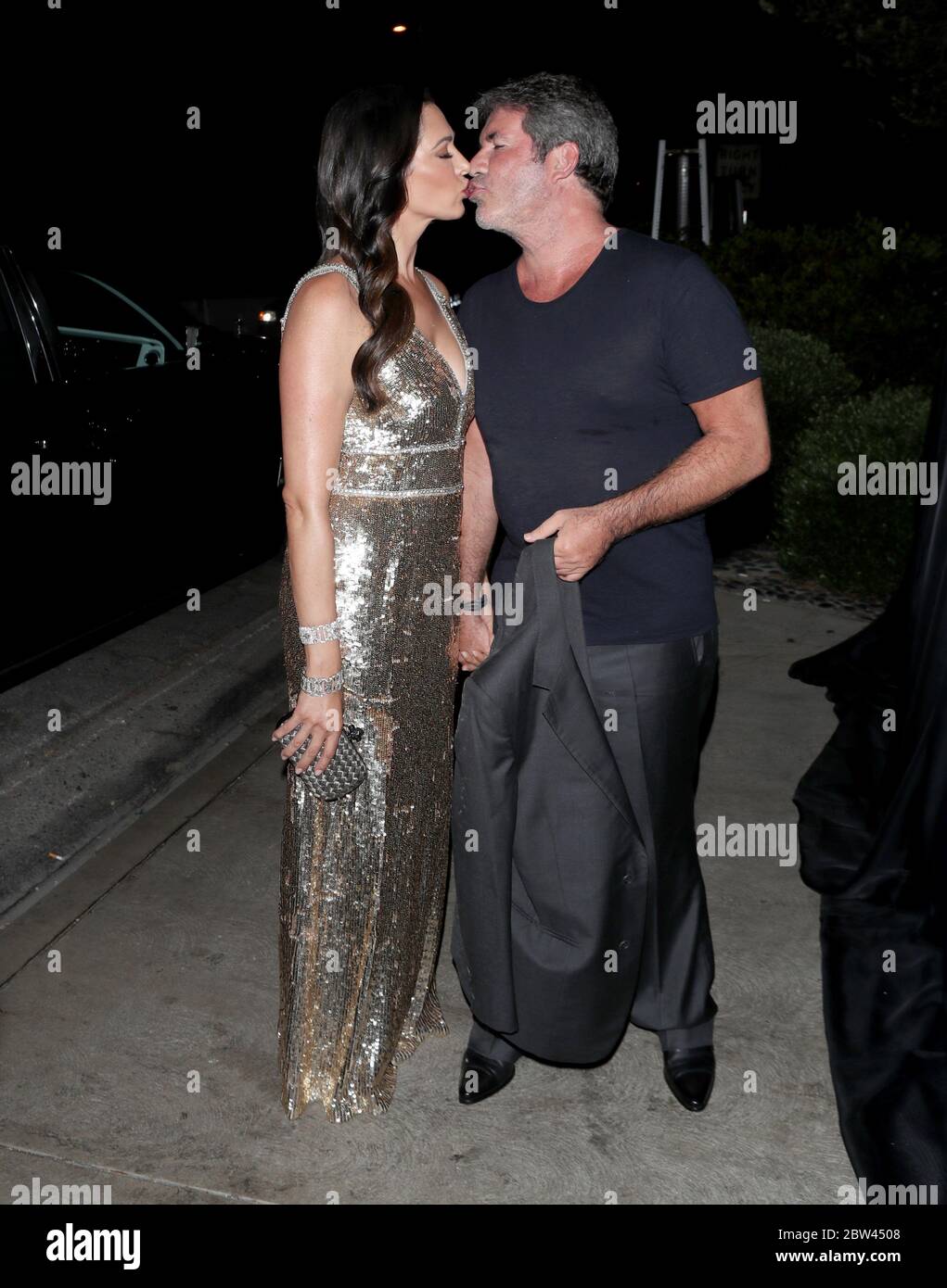 Simon Cowell and girlfriend Lauren Silverman in LA at a party to ...