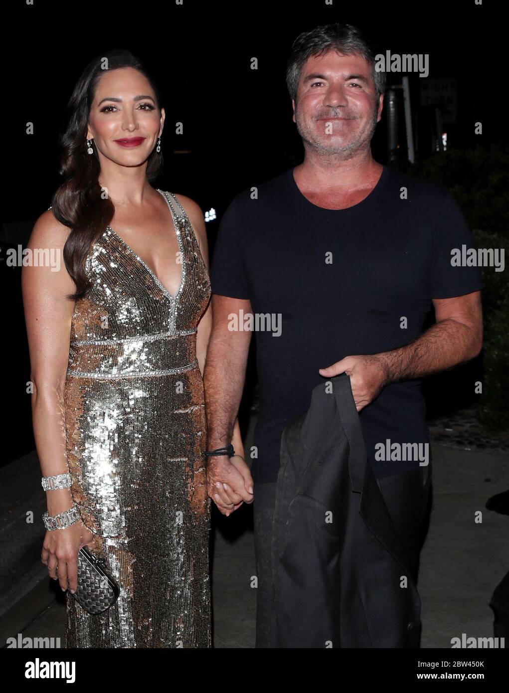Simon Cowell and girlfriend Lauren Silverman in LA at a party to ...