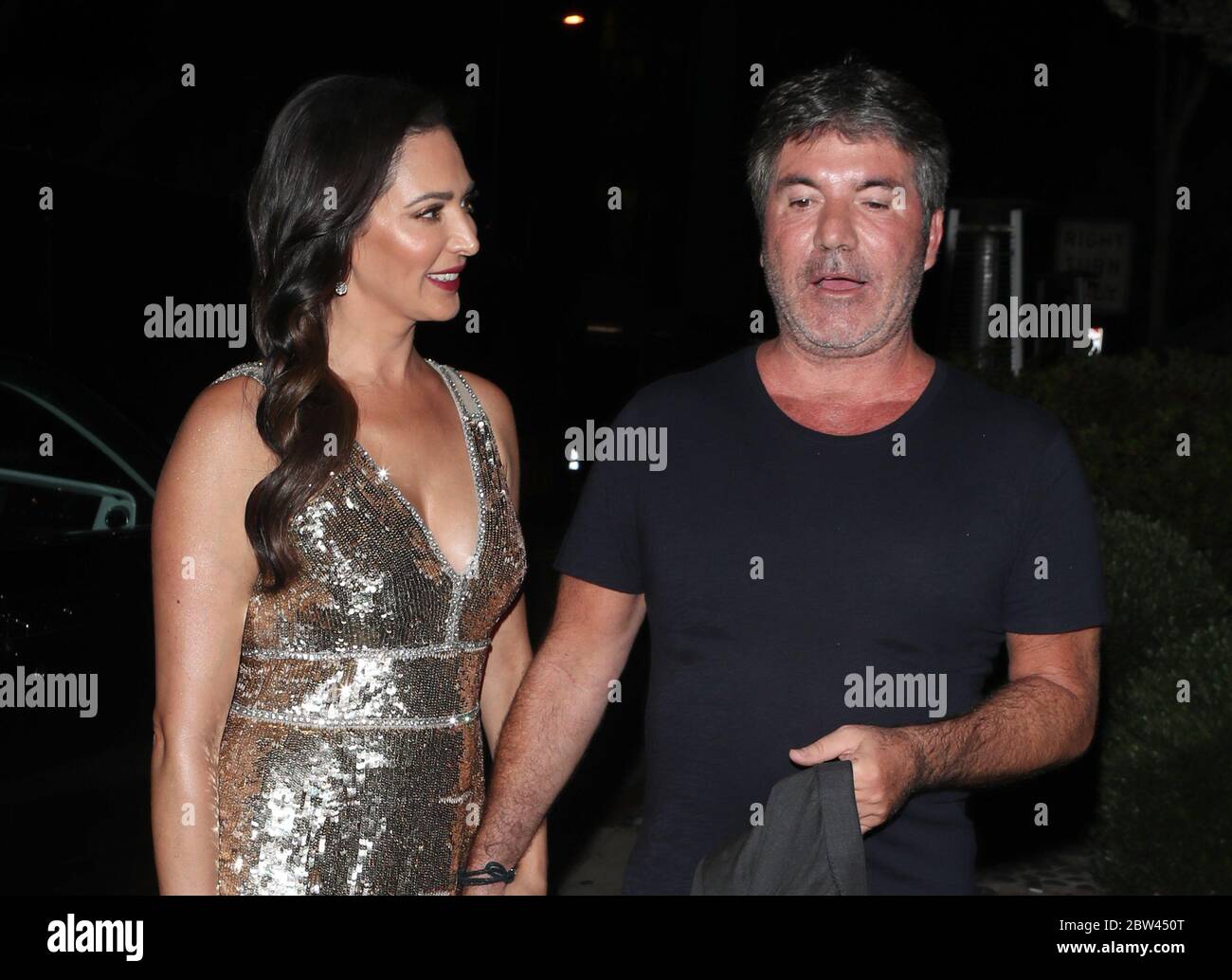 Simon Cowell and girlfriend Lauren Silverman in LA at a party to ...