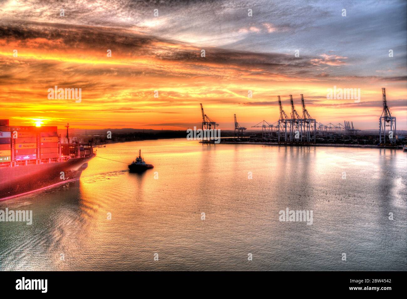 City of Southampton, England. Artistic sunset view of a container ship ...