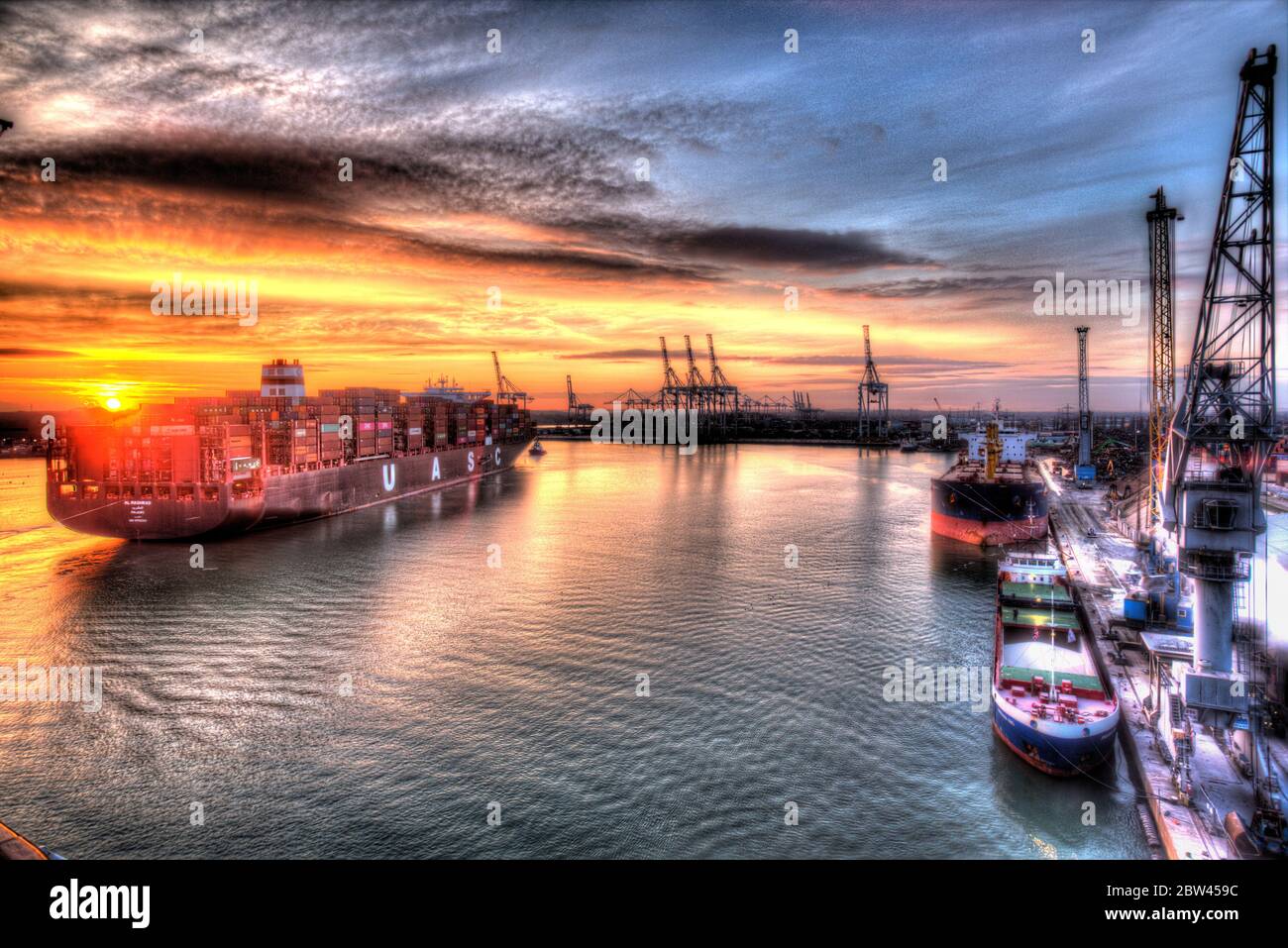 City of Southampton, England. Artistic sunset view of a container ship ...