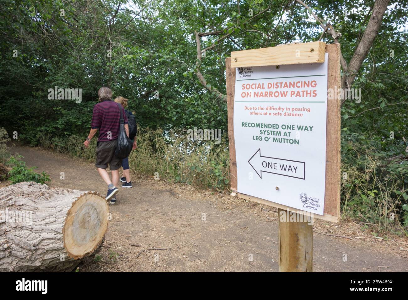 One Way Social Distancing Signage on narrow paths Stock Photo - Alamy