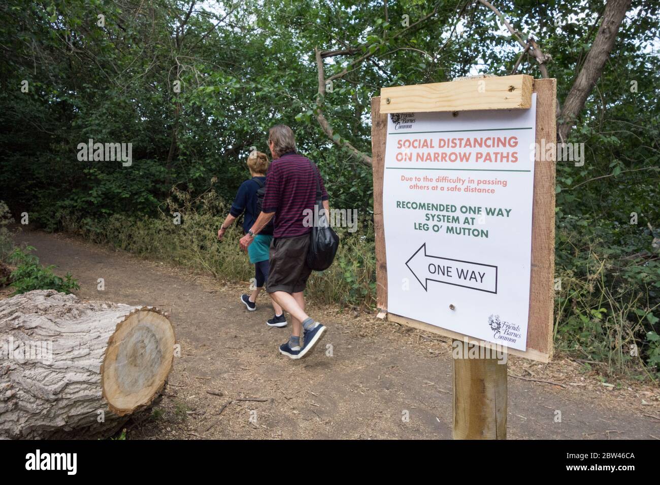 One Way Social Distancing Signage on narrow paths Stock Photo - Alamy