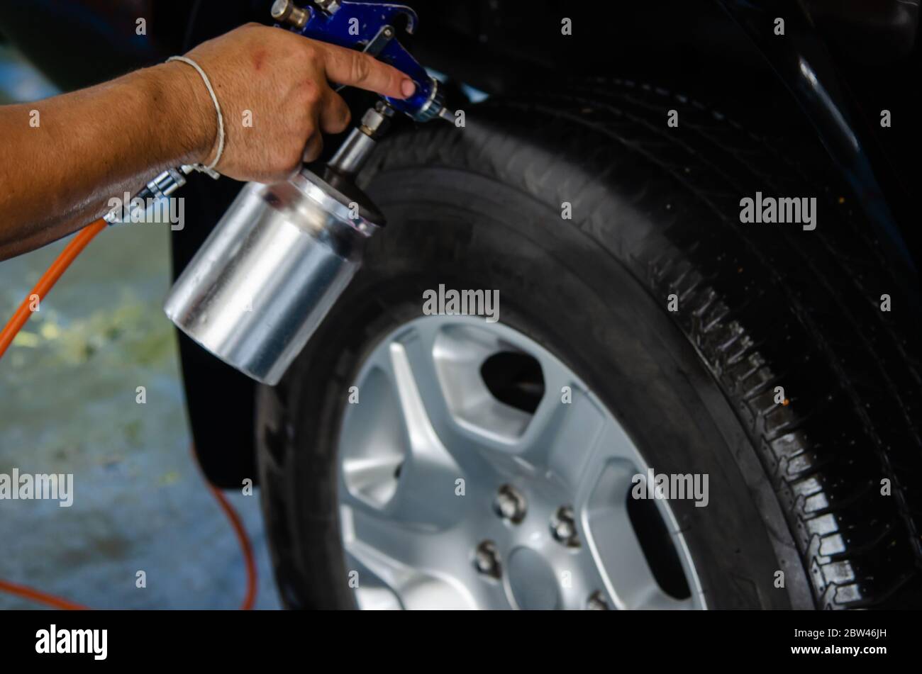 Car wash service. Use liquid spray coating wheel outside the wax Stock ...
