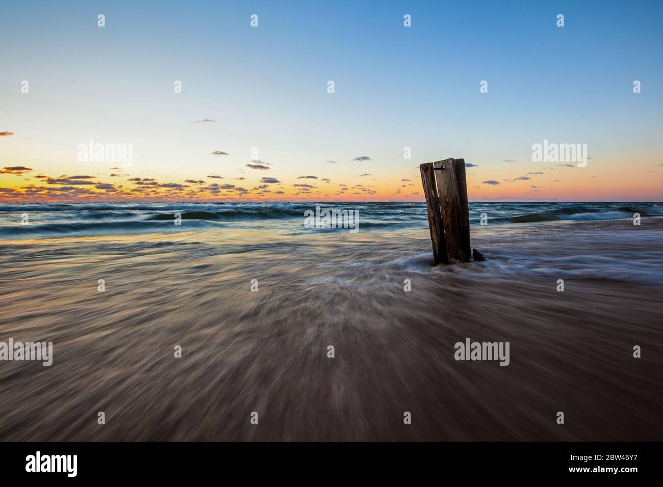 Long Exposure of the Waves of the Lake coming in Washing over the Sand ...