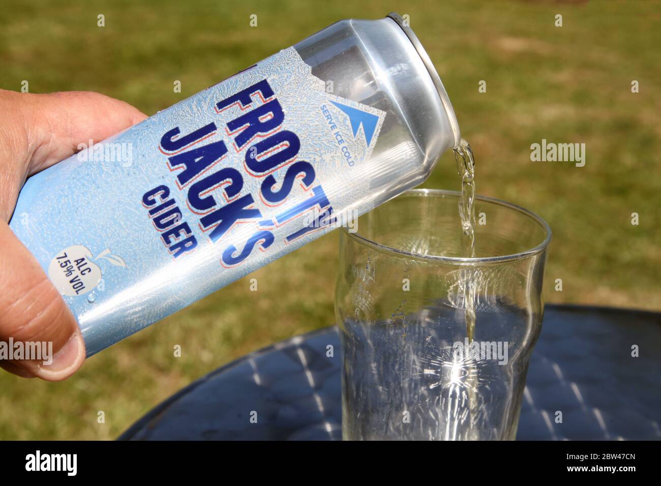 Frosty Jacks Cider in a can pouring cider into pint glass outside in ...
