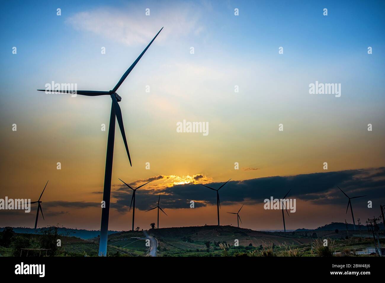 Wind Turbines over a sunset background Stock Photo - Alamy