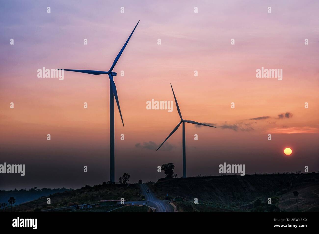 Wind Turbines over a sunset background Stock Photo - Alamy