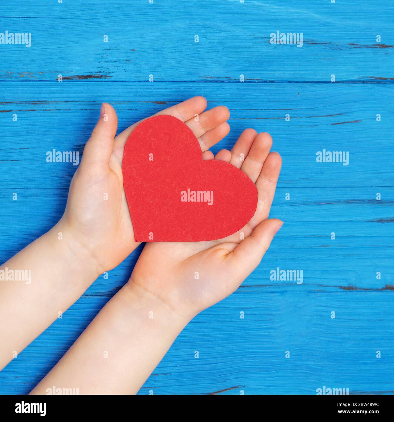 People hold hands over heart hi-res stock photography and images - Alamy