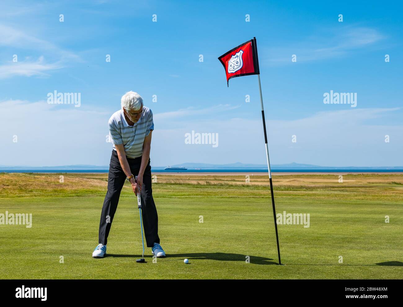 Man playing golf on putting green, Golf Club reopening, Kilspindie golf ...