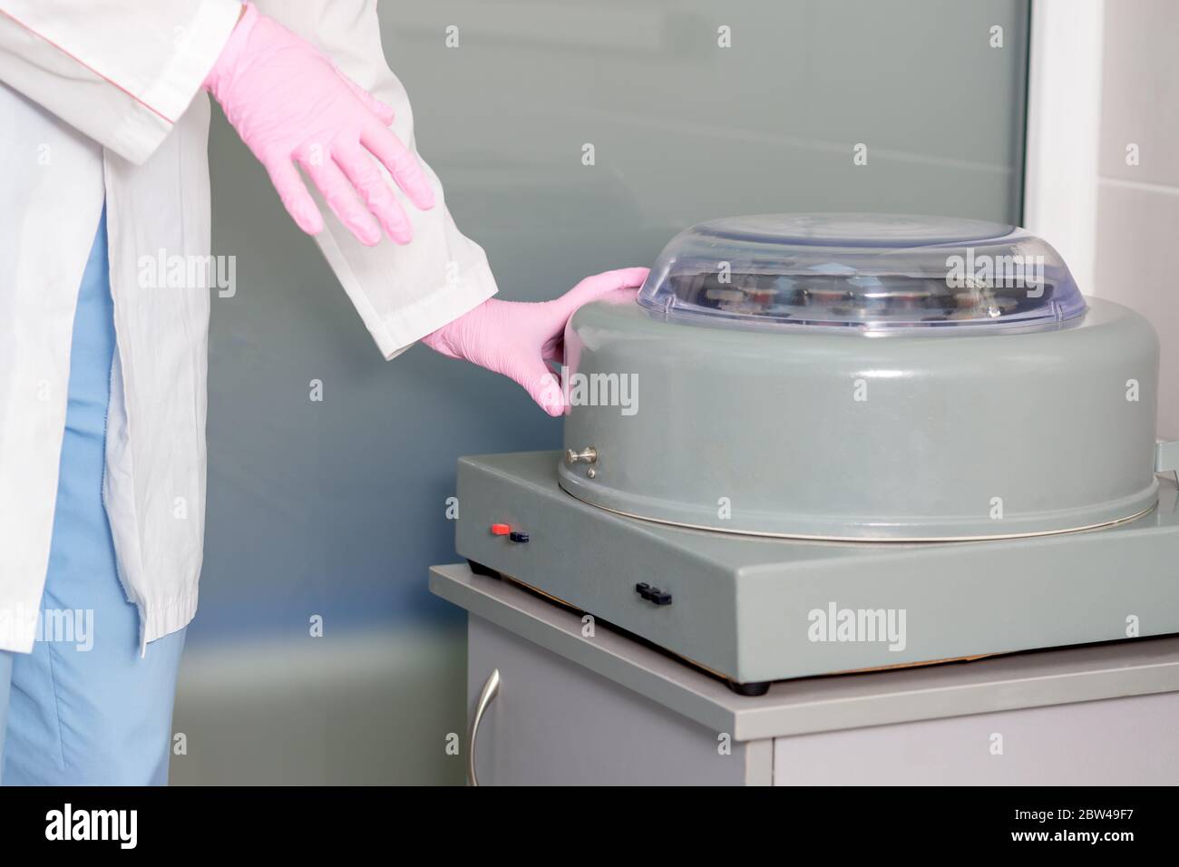 Hands of nurse are using centrifuge machine in medical lab Stock Photo ...