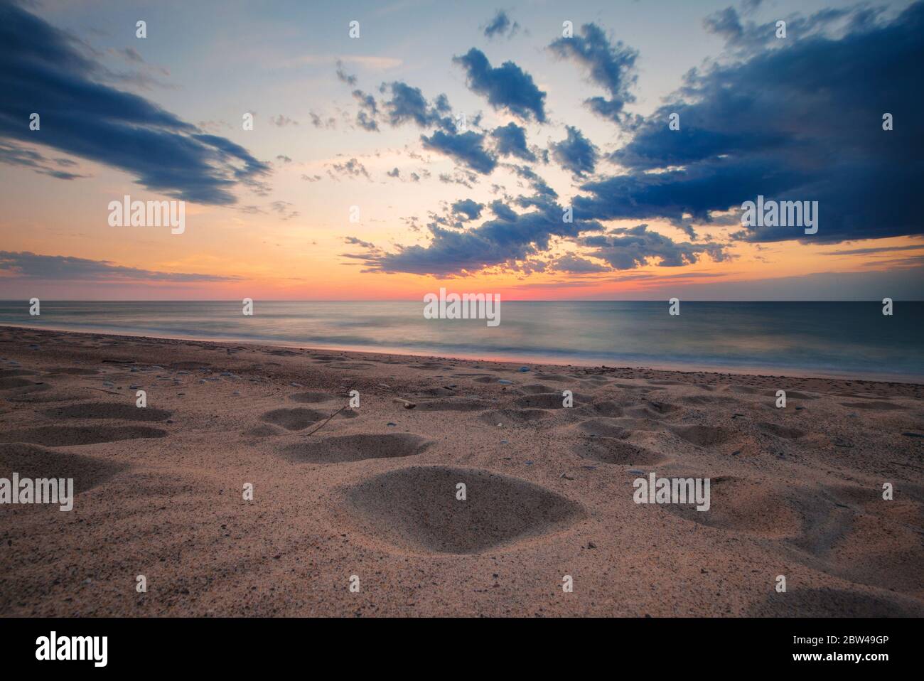 Colorful Golden Hour of the Sunset on Beach over the Blue Waves of the ...