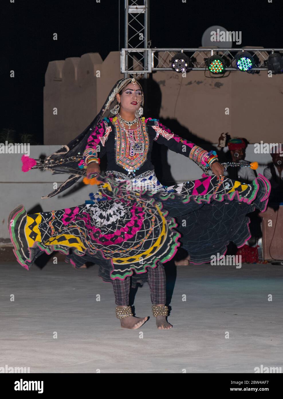 Indian female artist performing Kalbelia folk dance with mud pots in ...