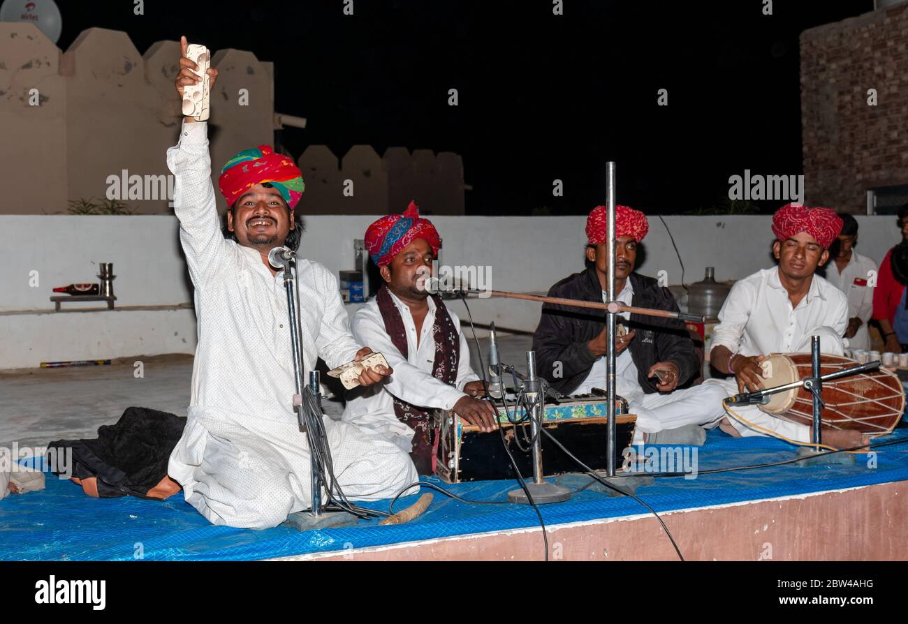 A Male artists performing with indian musical instruments in thar ...
